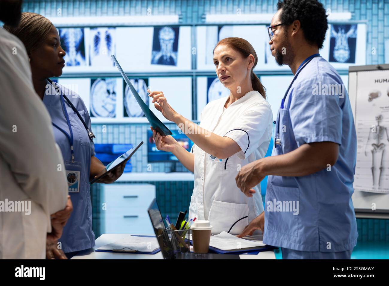 Doctors and nurses analyze human anatomy scans results in a treatment ...