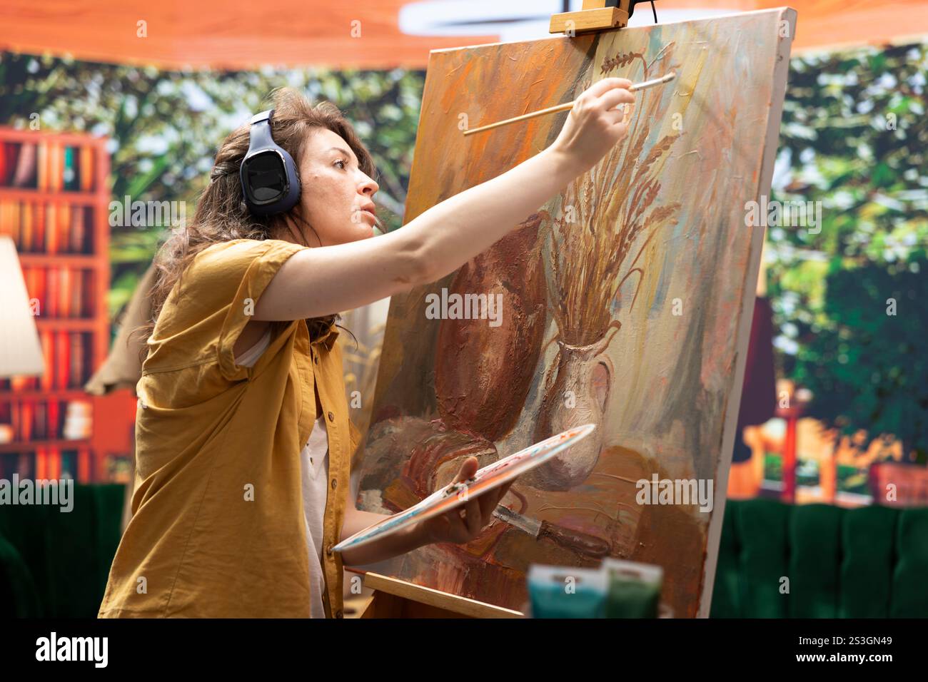 Artist in a gallery atelier works on a new colorful masterpiece ...