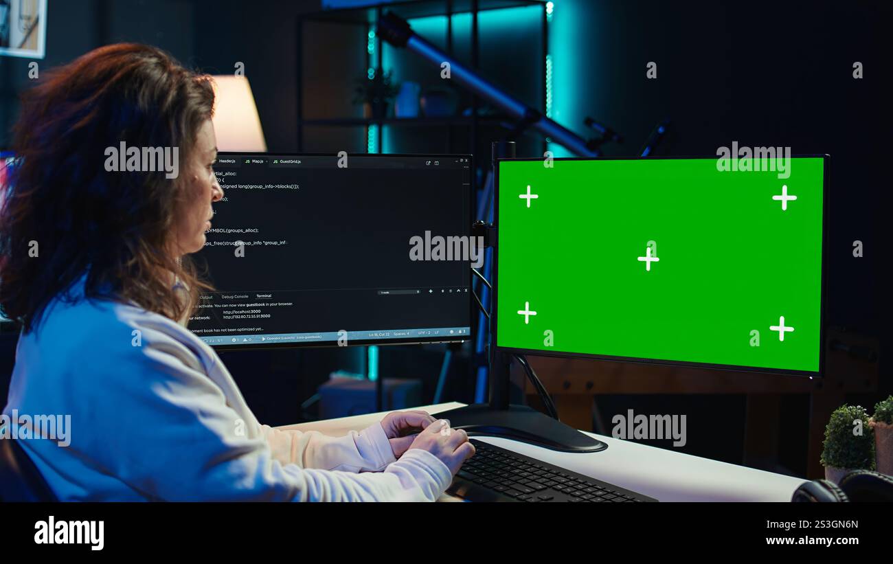 Cybersecurity expert uses green screen computer to look for security vulnerabilities and ...