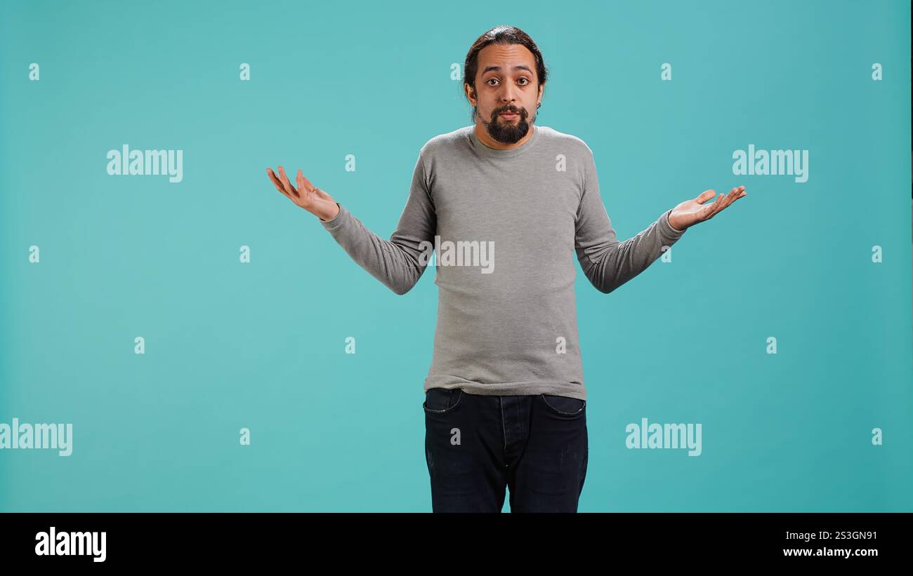 Man shrugging shoulders, unable to provide answer, having detached ...