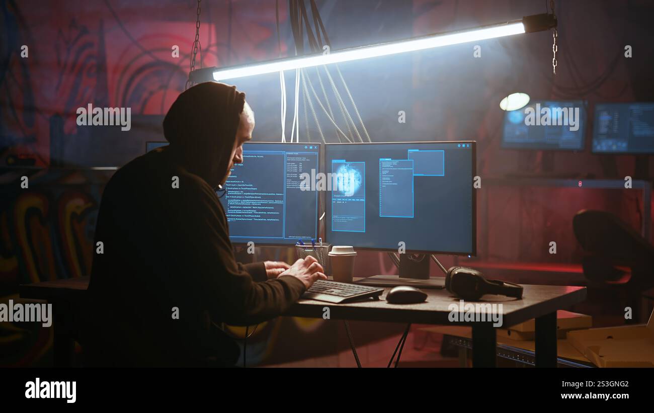 Hacker using high tech computer system to run malicious code in foggy ...