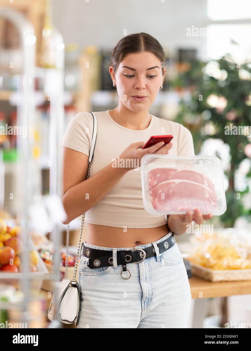 Young woman scanning qr code of raw entrecote Stock Photo - Alamy