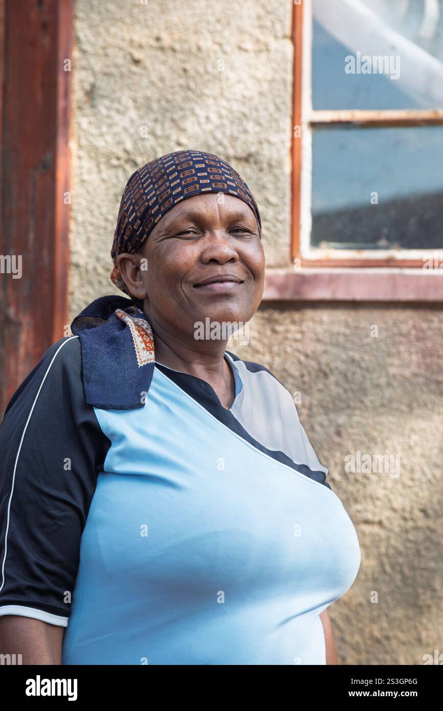 african village, portrait smiling african woman mature with a scarf, on ...