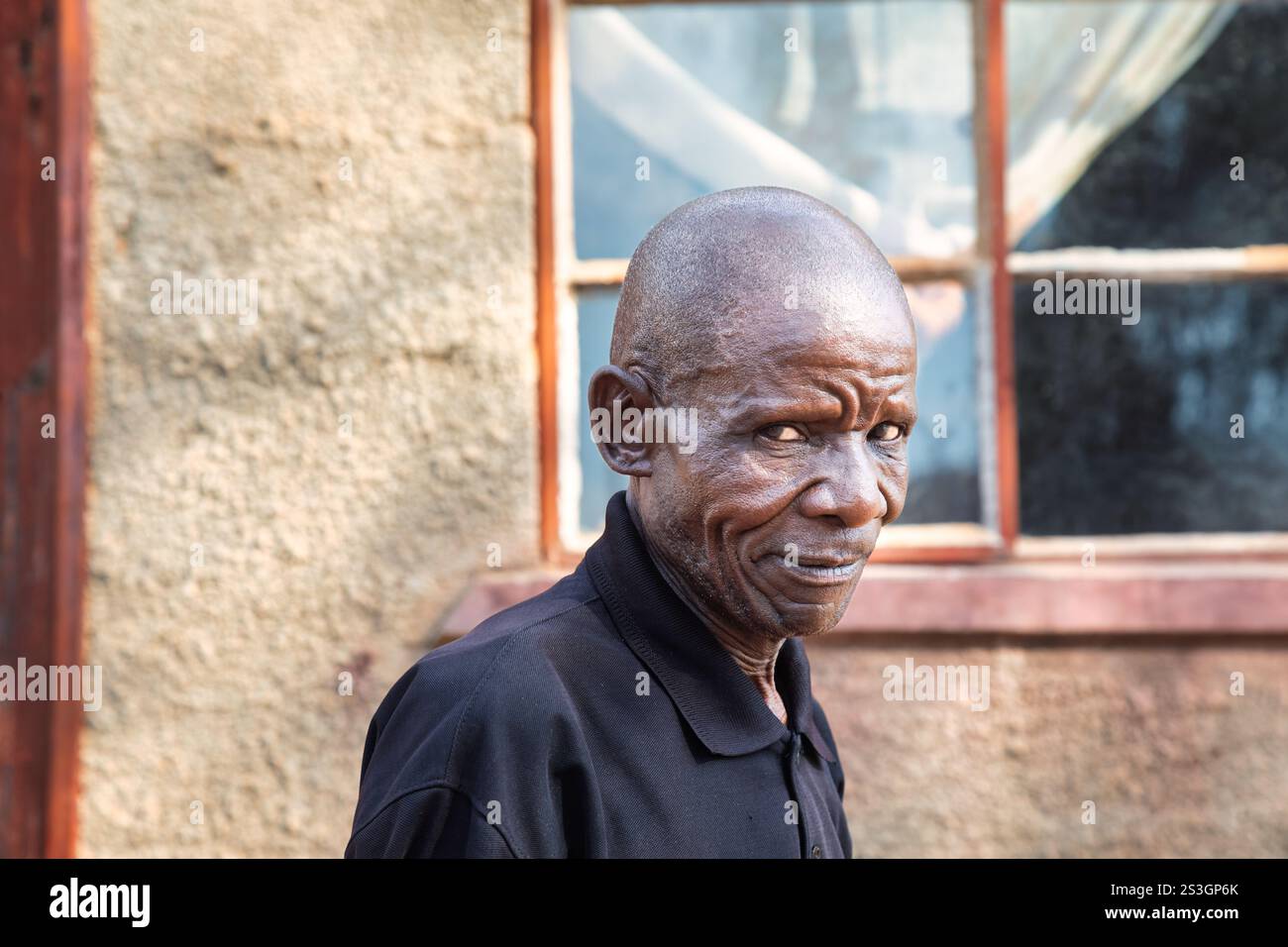 african village, portrait single smiling old african man, in front of ...