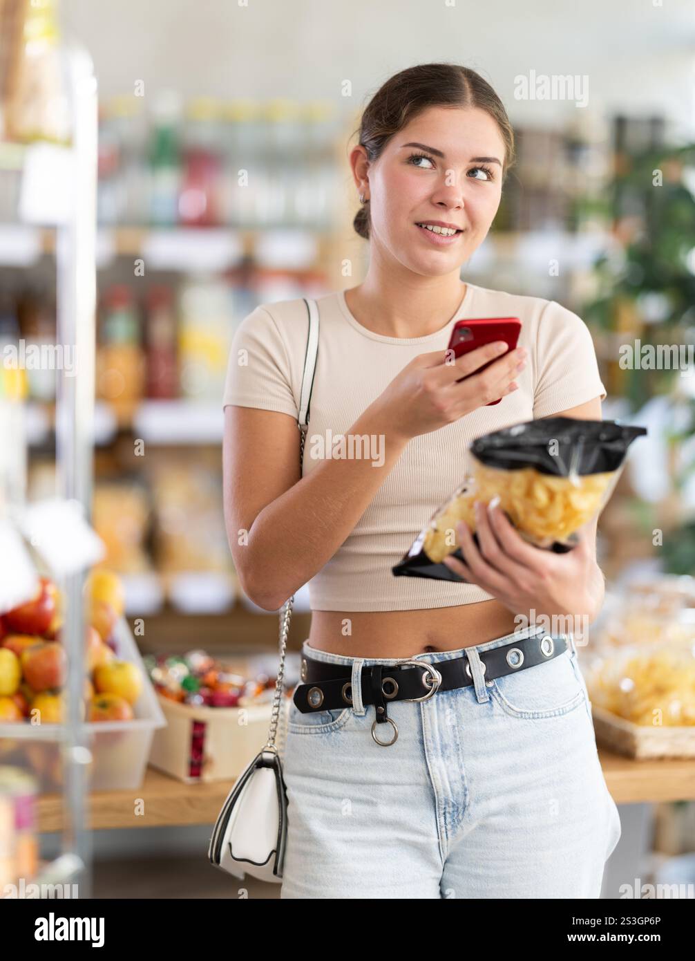 Young woman scanning qr code for chips Stock Photo - Alamy