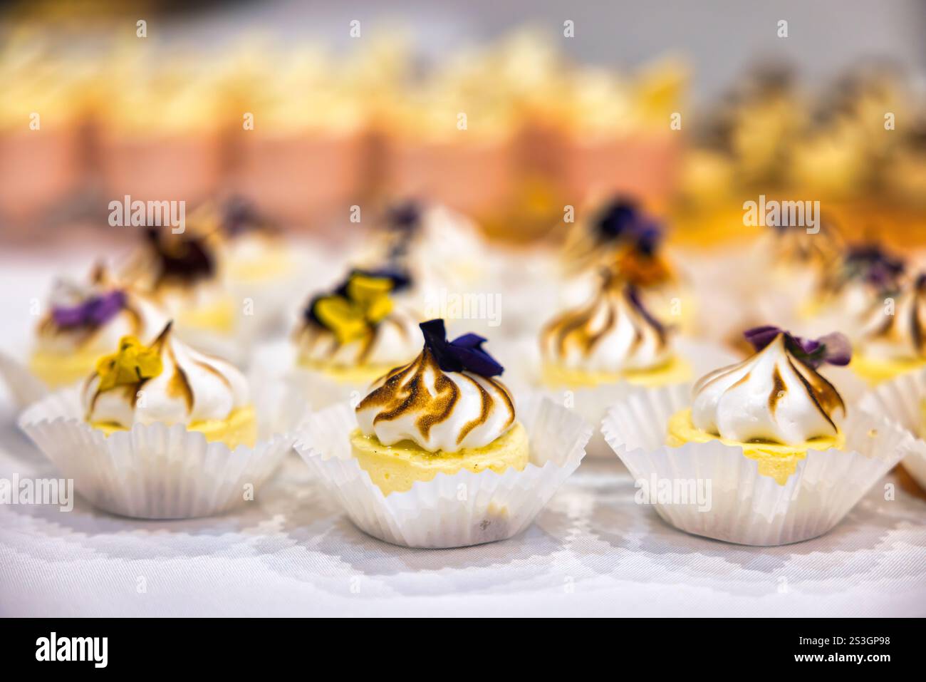 cake mini with edible flowers, patisserie lemon tart meringue Stock ...