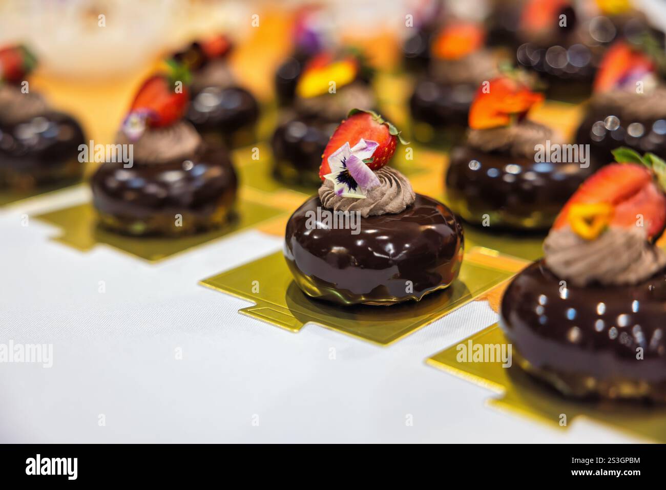 Dark chocolate mousse cakes with strawberry and edible flowers. mini ...