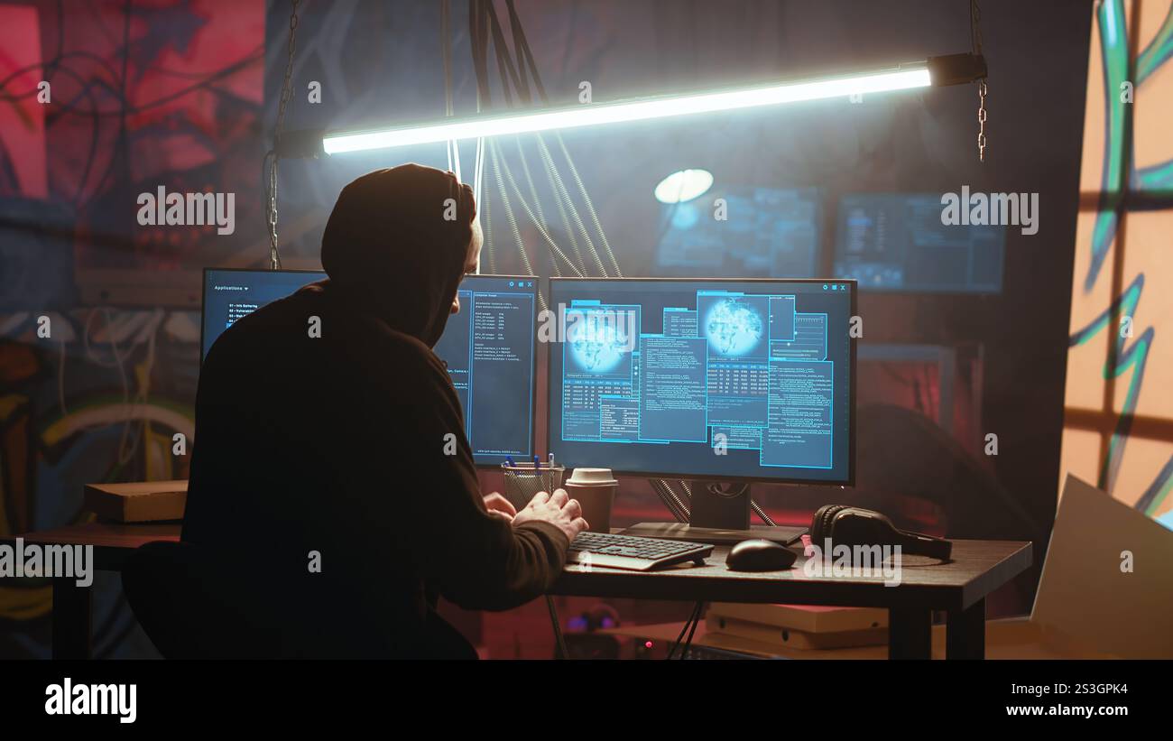 Hacker using high tech computer system to run malicious code in foggy ...