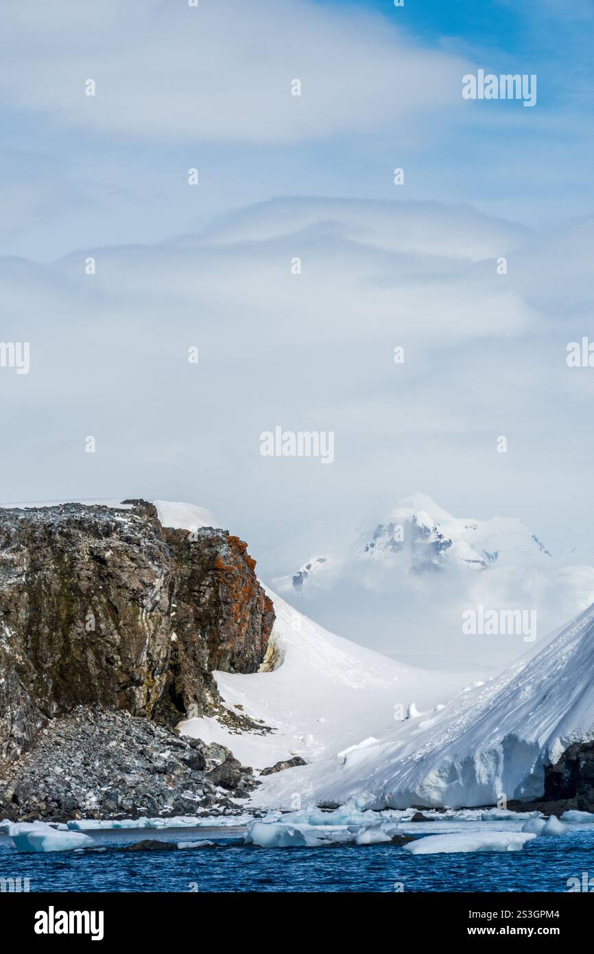 Detail of the antarctic coastline, showing sea ice and snow-capped ...