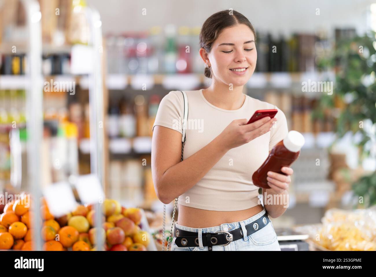 Young woman scanning qr code for ketchup Stock Photo - Alamy