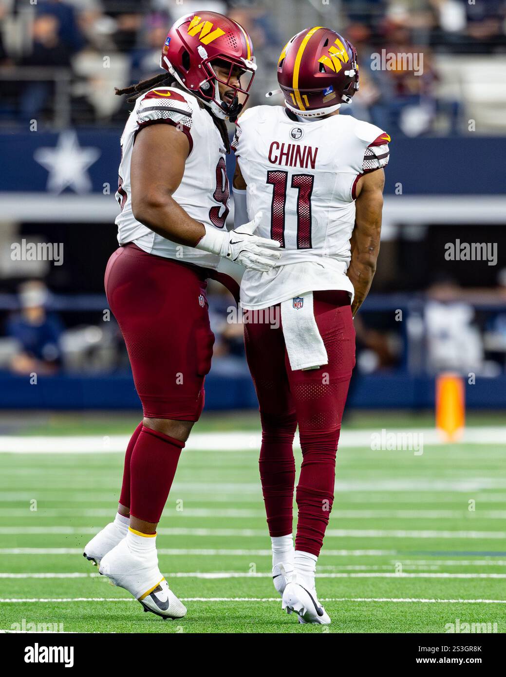 Washington Commanders safety Jeremy Chinn (11) and defensive end Jer ...