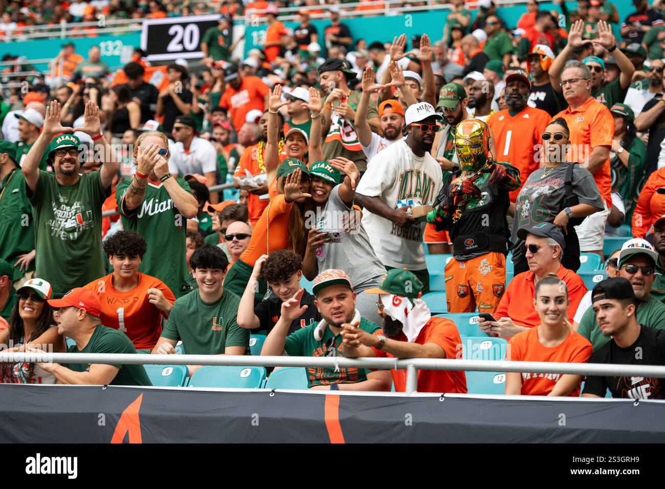 University of Miami fans celebrate in the crowd during an NCAA football ...