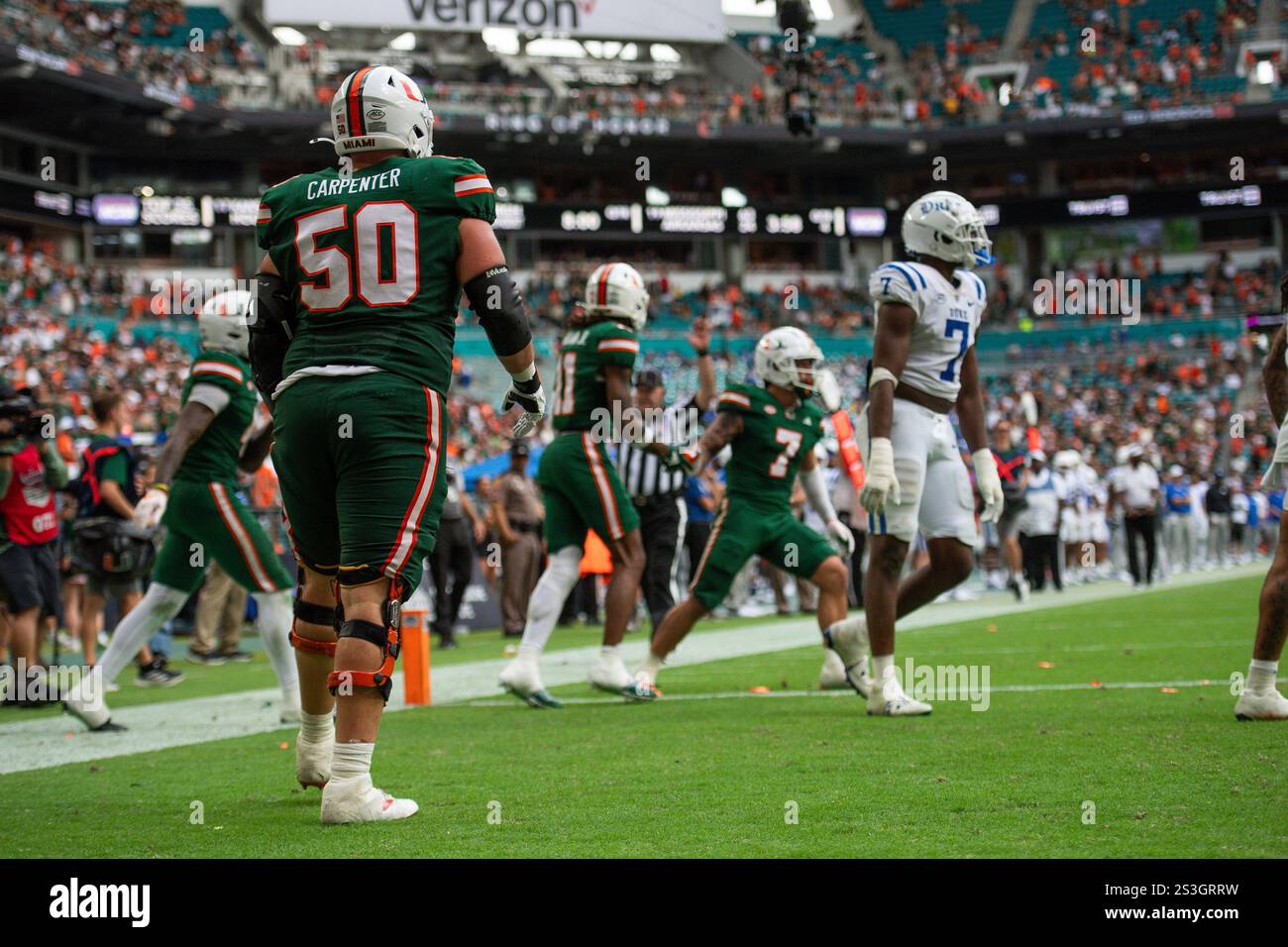 Miami center Zach Carpenter (50) and others celebrate during an NCAA ...