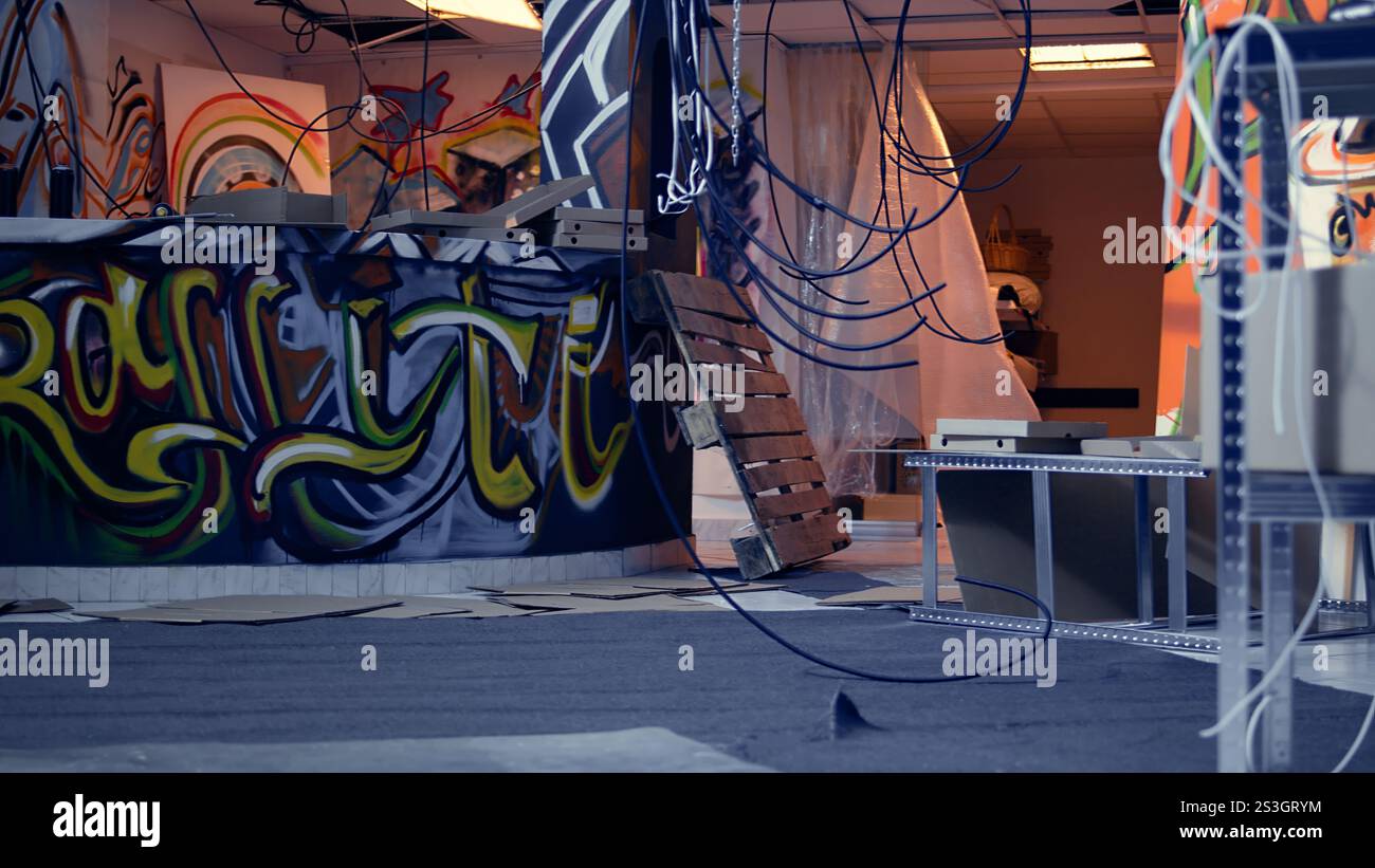 Empty derelict building with creative graffiti street art on walls, concept of alternative ...