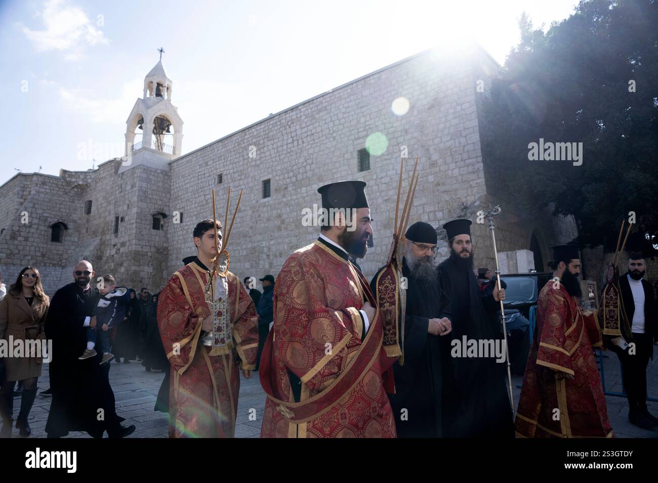 Greek Orthodox clergy walk in procession to receive the Patriarch at ...