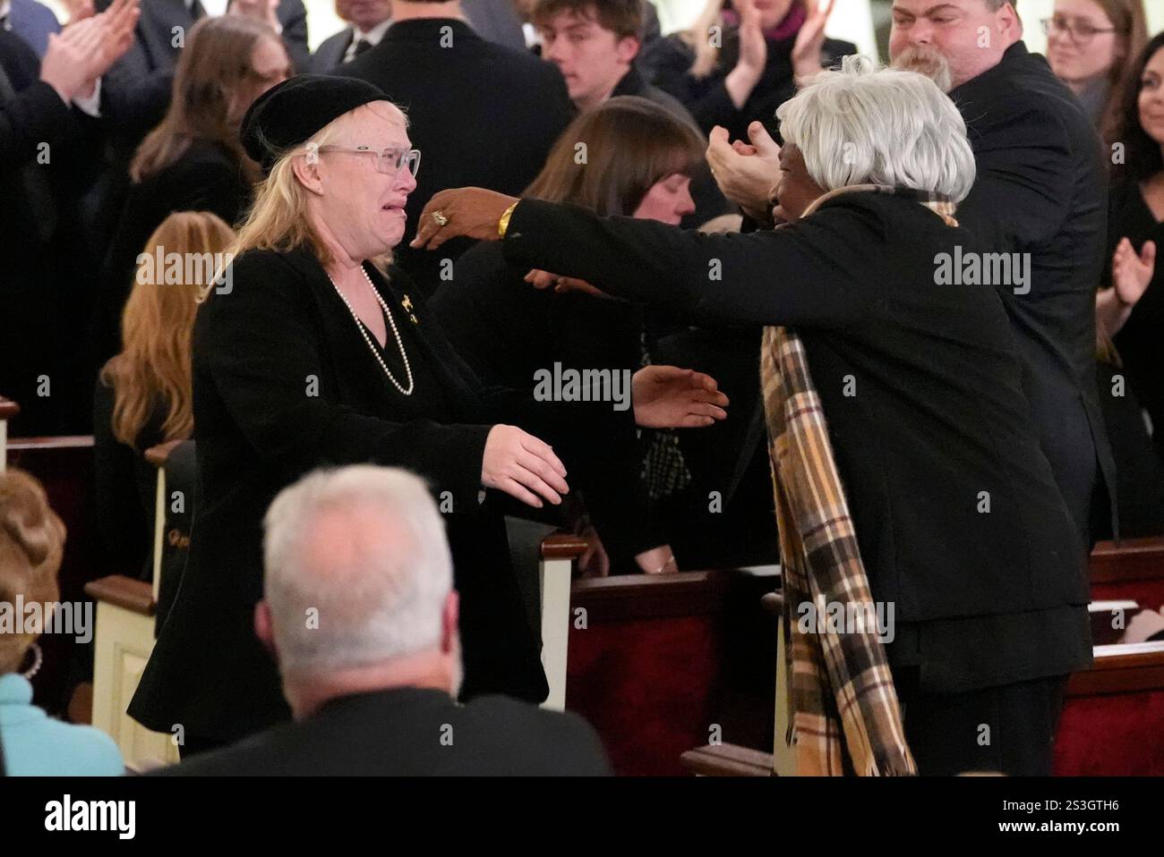Amy Carter hugs her nanny Mary Prince during the funeral service for ...