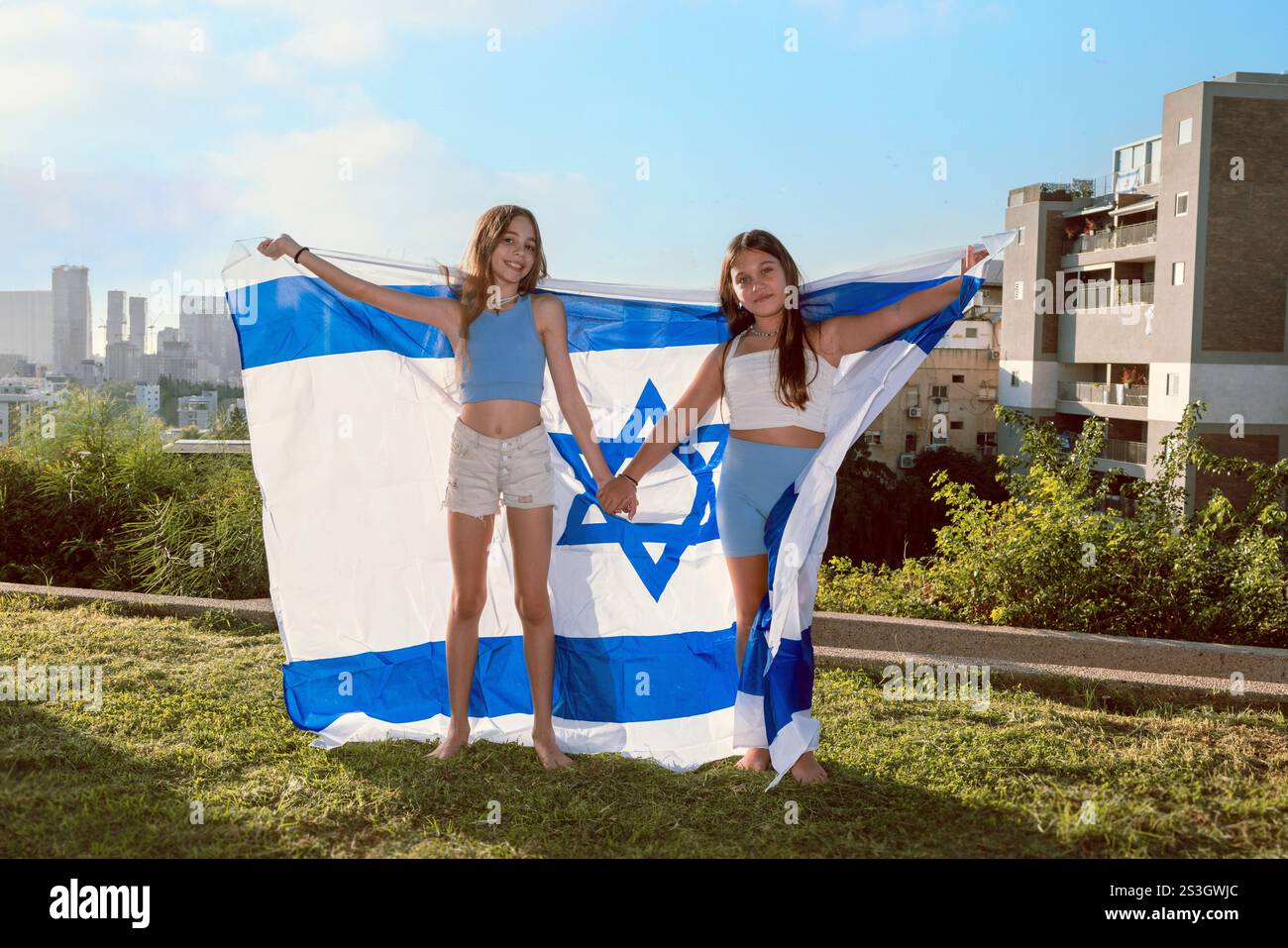 Two happy girls are proud to be Israeli and hold the Israel flag ...