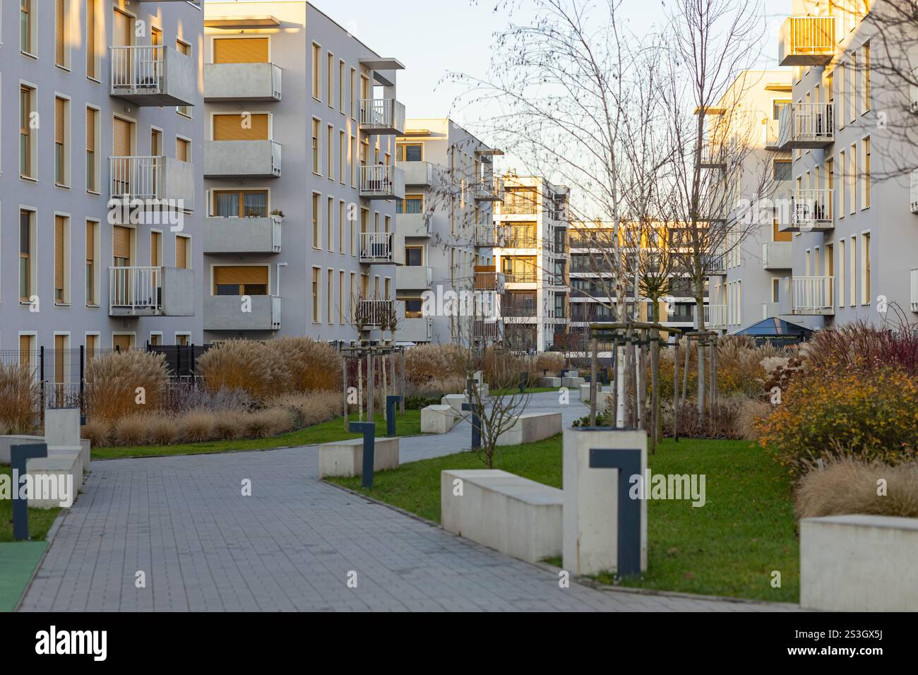 Residential apartment complex with green courtyard, paved pathways ...
