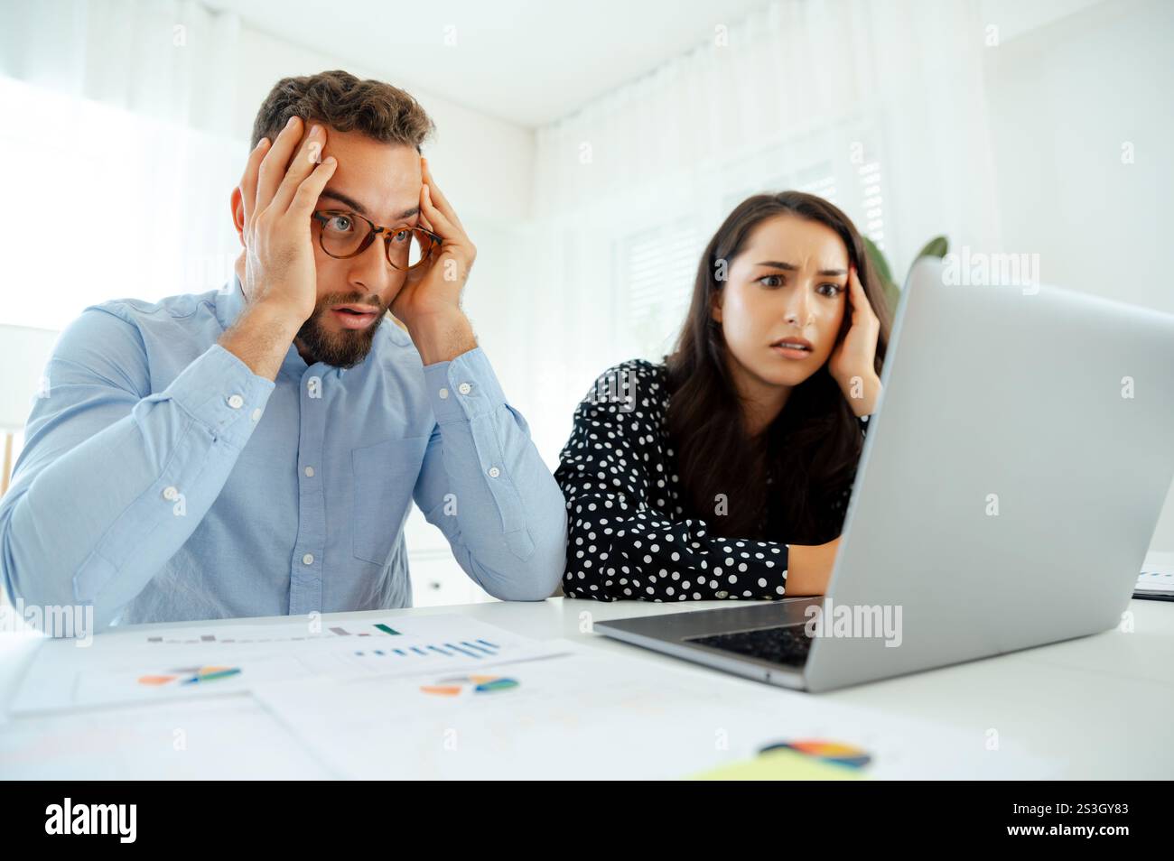 Shocked young company colleagues at a modern office, analyzing ...