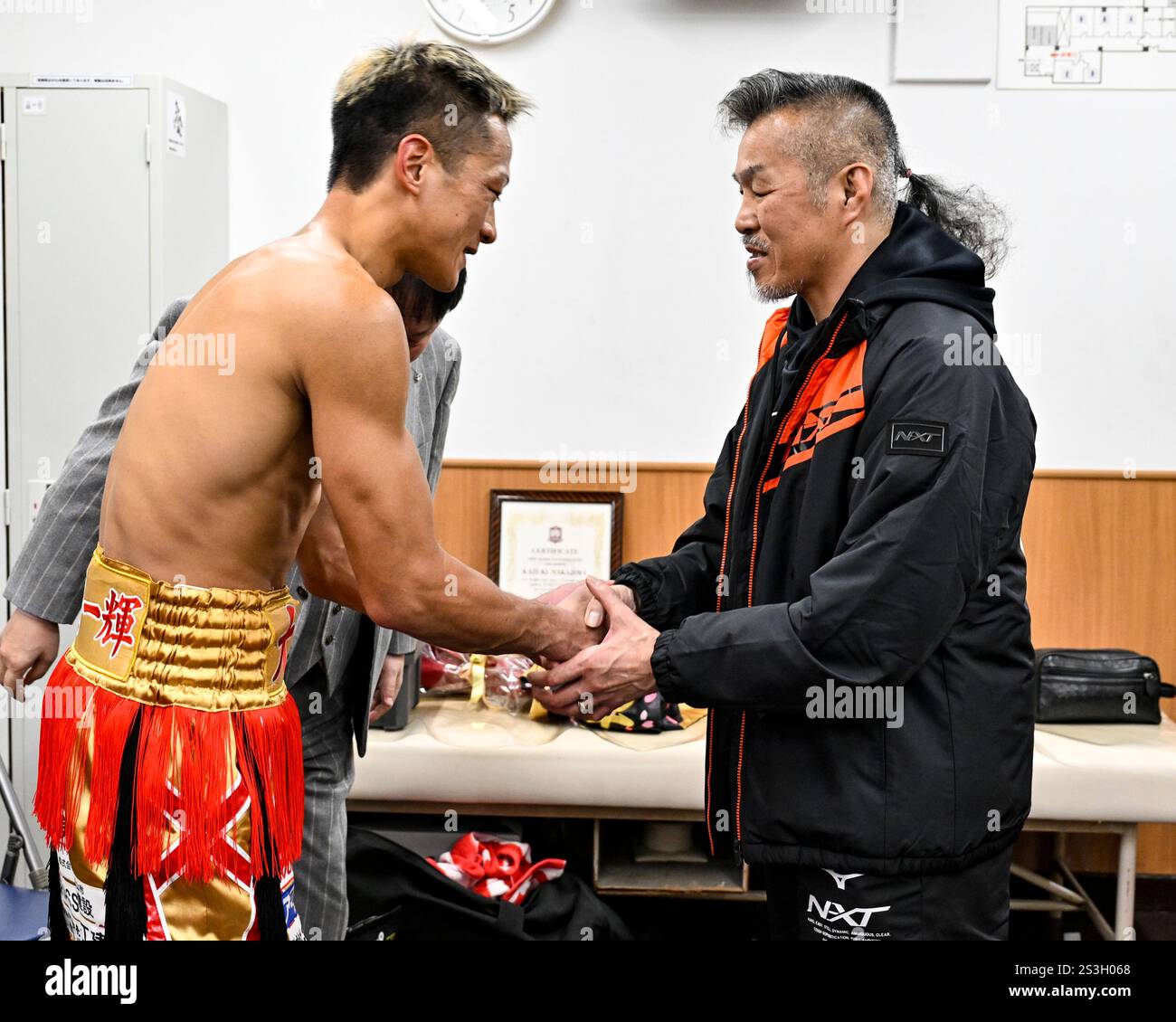 Tokyo, Japan. 12th Dec, 2024. Champion Kazuki Nakajima, left, shakes ...