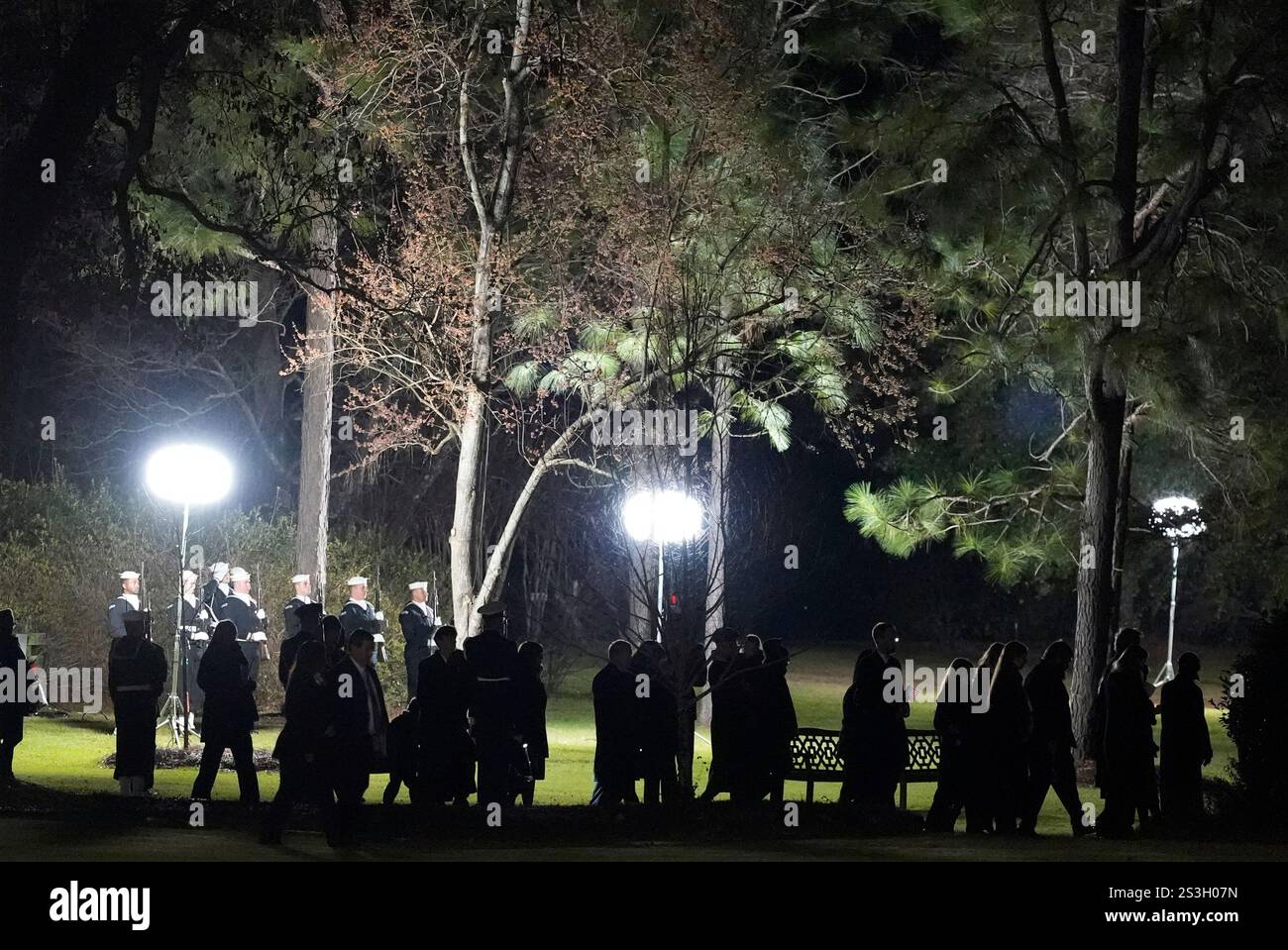 Members of the Carter family walk to the burial site of former ...