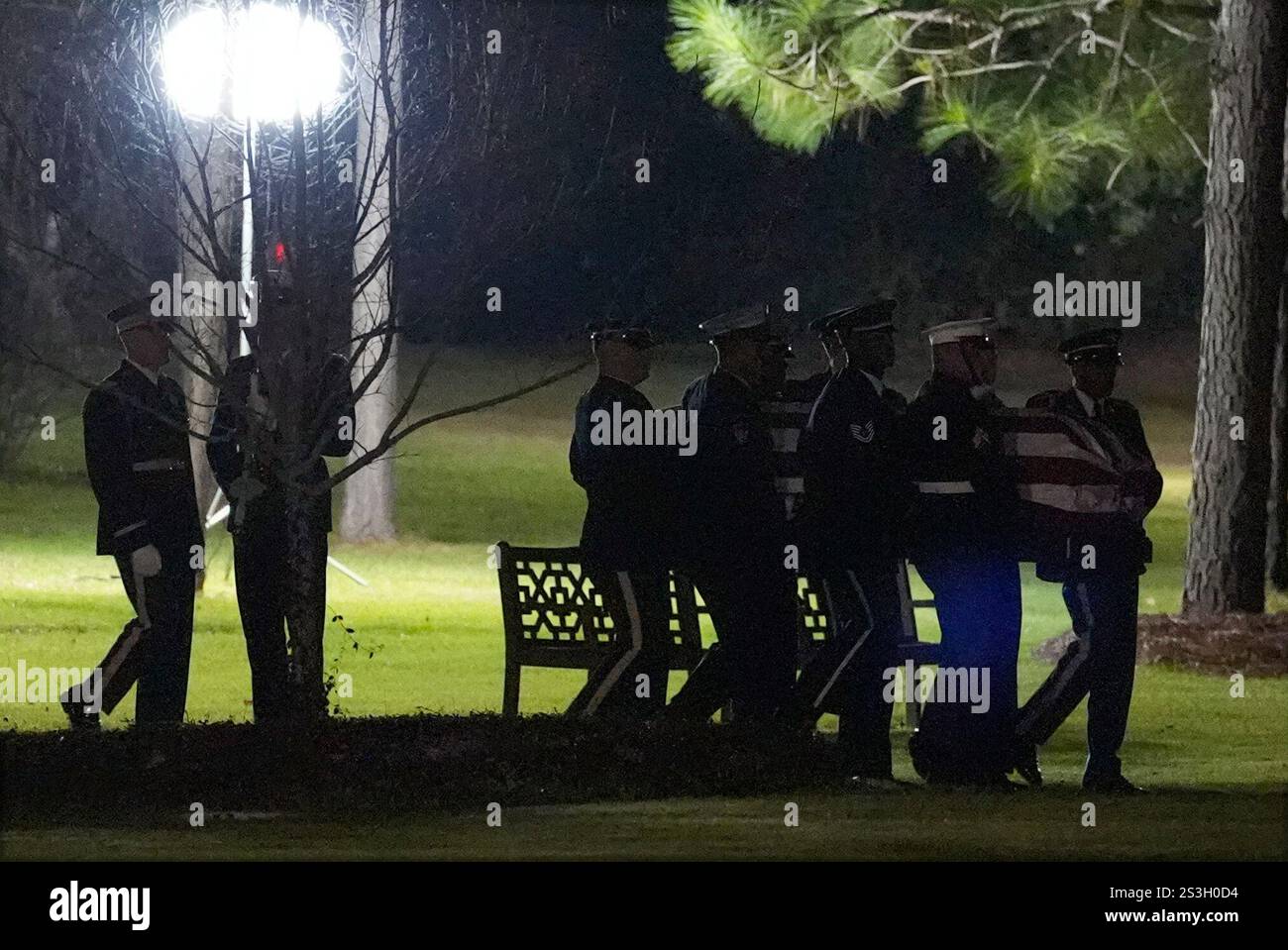 A joint services body bearer team carries the casket of former ...