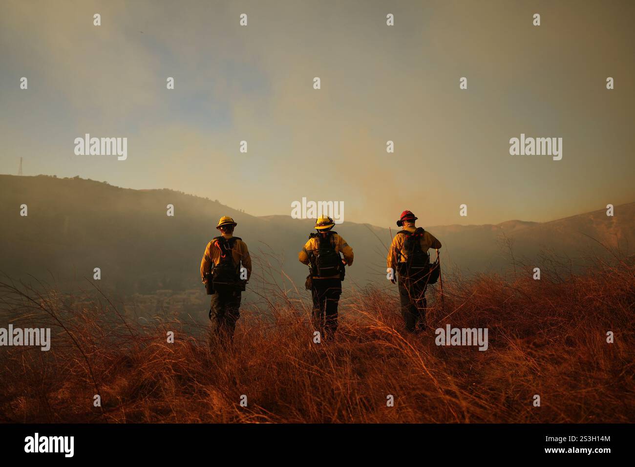 Firefighters look out over the Kenneth Fire, Thursday, Jan. 9, 2025, in ...