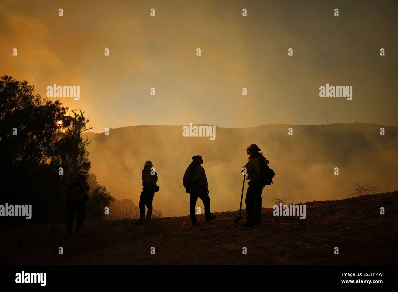 Firefighters look out over the Kenneth Fire, Thursday, Jan. 9, 2025, in ...