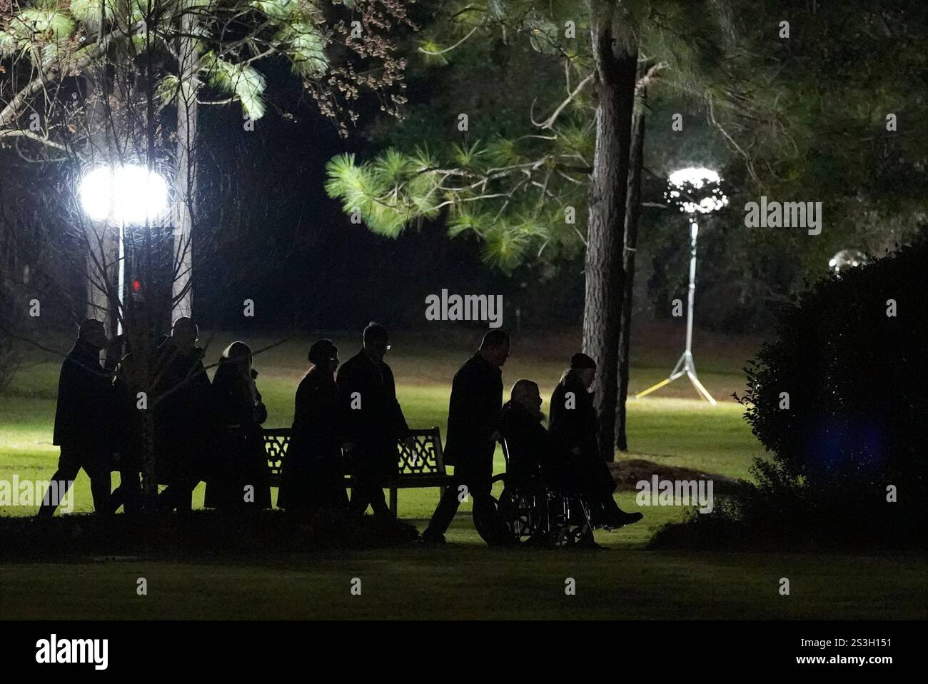 Members of the Carter family walk to the burial site of former ...