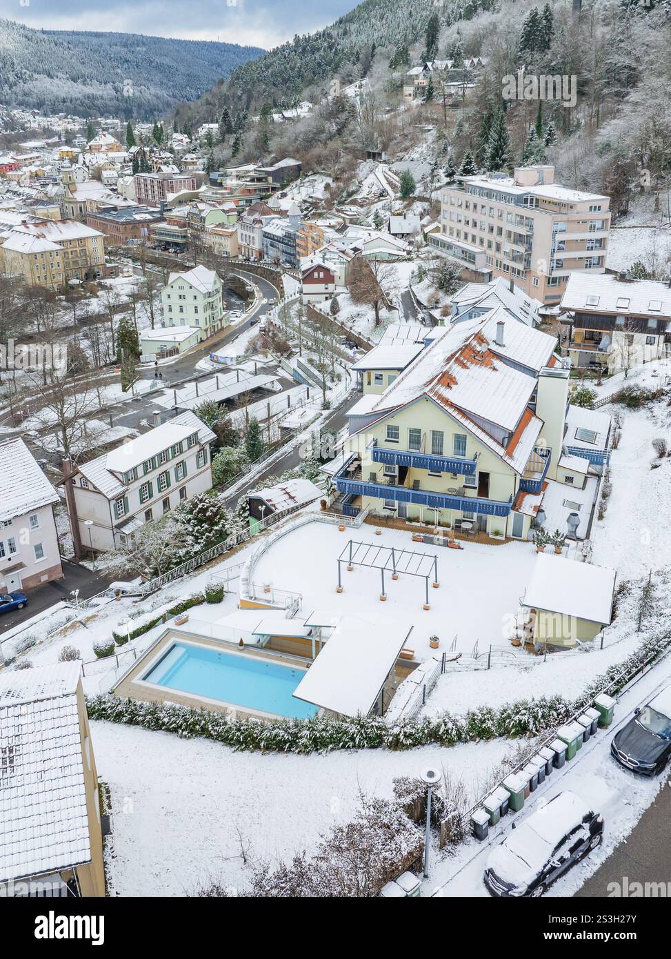 Snowy town view with a swimming pool and colourful houses in ...