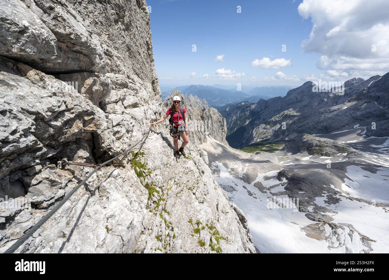Mountaineer with helmet in a secured via ferrata, Zugspitz via ferrata ...