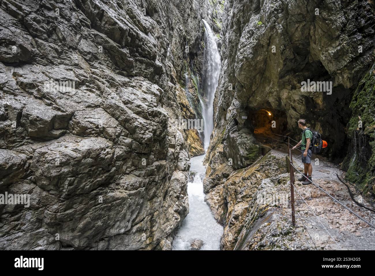 Waterfall and mountain stream Hammersbach in a canyon, mountaineers on ...