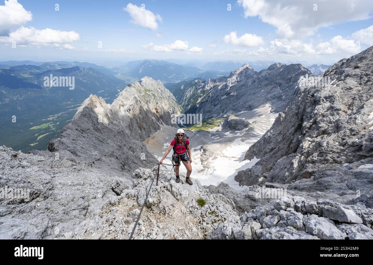Mountaineer with helmet in a secured via ferrata, Zugspitze via ferrata ...