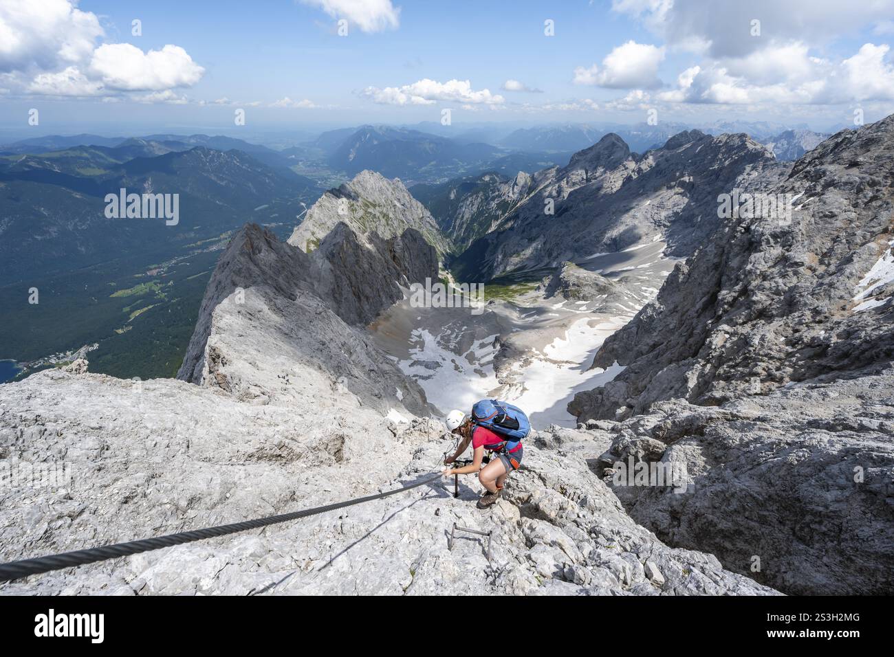 Mountaineer with helmet in a secured via ferrata, Zugspitze via ferrata ...