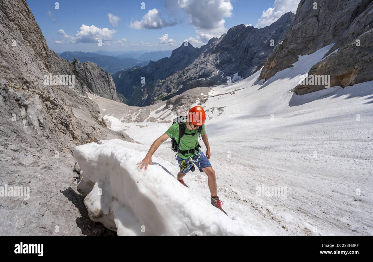 Mountaineer on a snowfield, mountain basin with glacier remnant of the ...