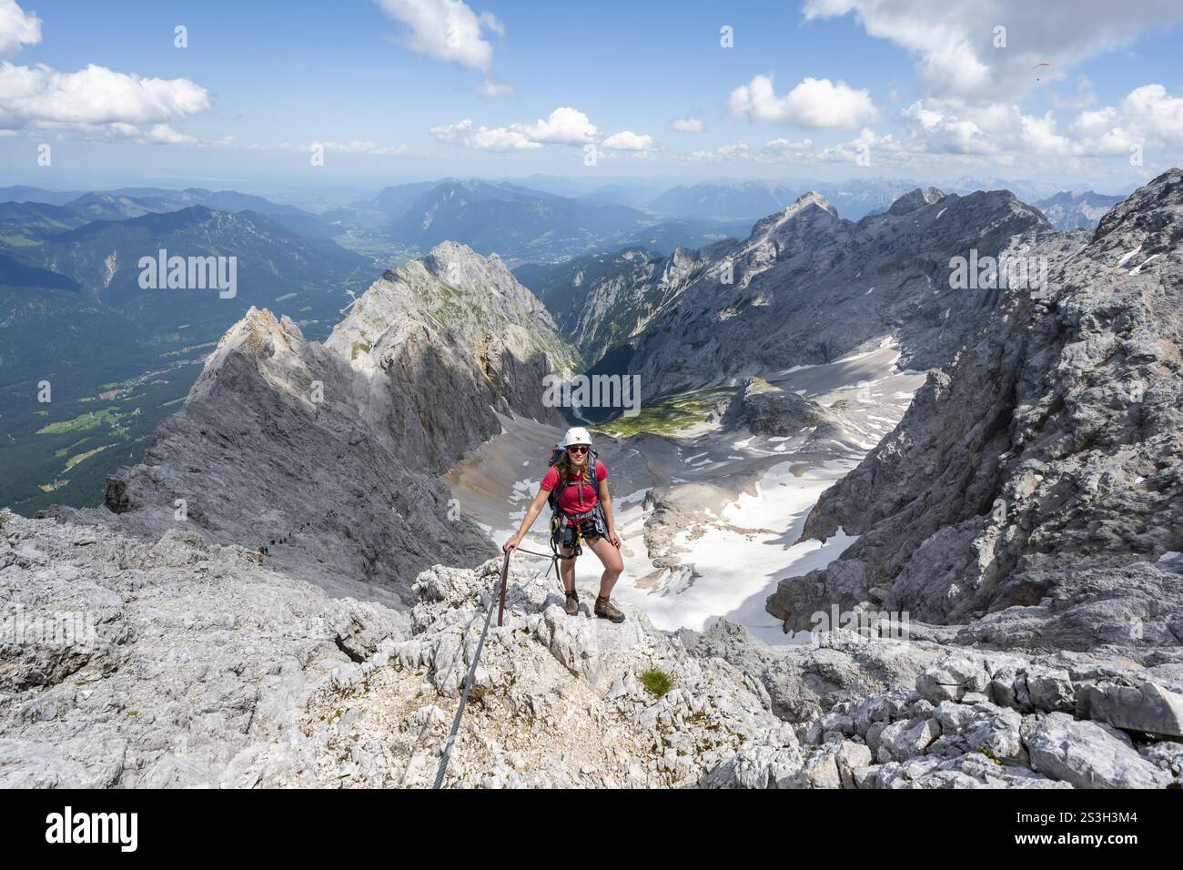 Mountaineer with helmet in a secured via ferrata, Zugspitze via ferrata ...