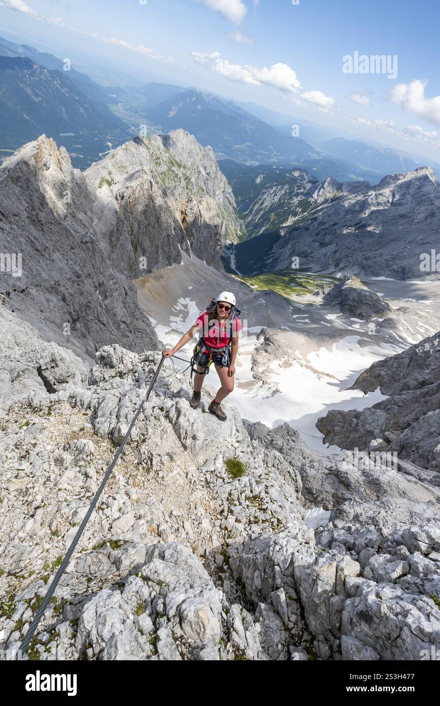 Mountaineer with helmet in a secured via ferrata, Zugspitze via ferrata ...