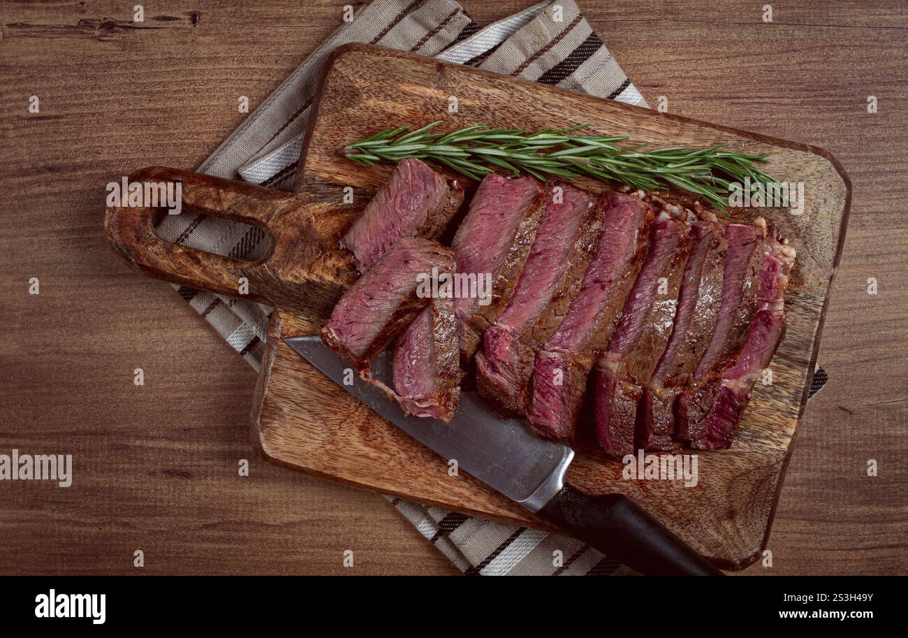 Fried steak, beef steak, rib eye steak, sliced steak, on a chopping ...