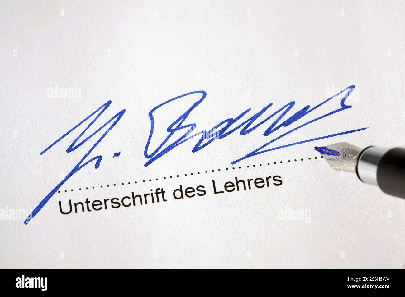 Handwritten signature under an official document of the school Stock ...