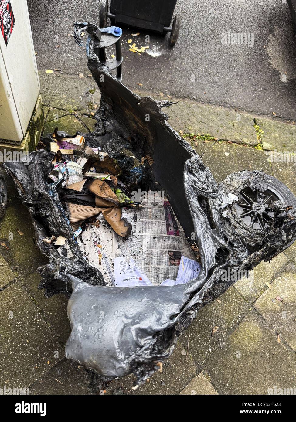 A picture of a heavily melted rubbish bin that has obviously been ...