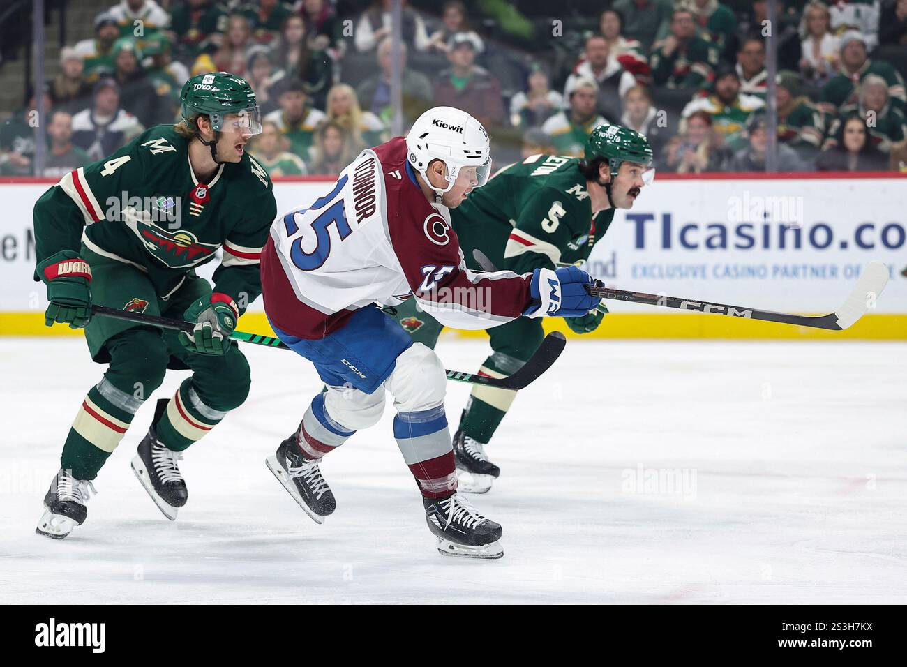 Colorado Avalanche right wing Logan O'Connor, middle, shoots the puck ...