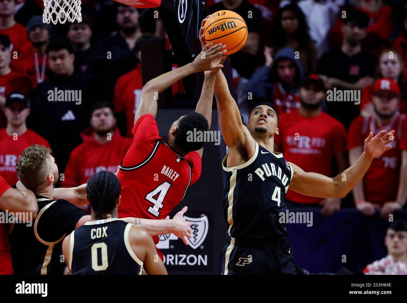 Purdue forward Raleigh Burgess (34) blocks the shot of Rutgers guard ...