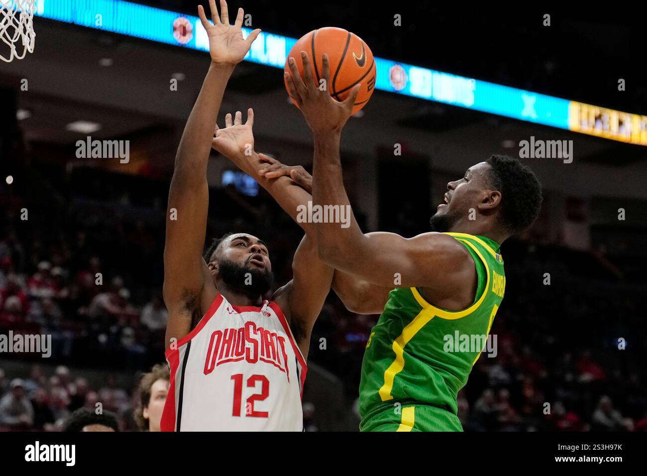 Oregon guard TJ Bamba, right, shoots as Ohio State guard Evan Mahaffey ...