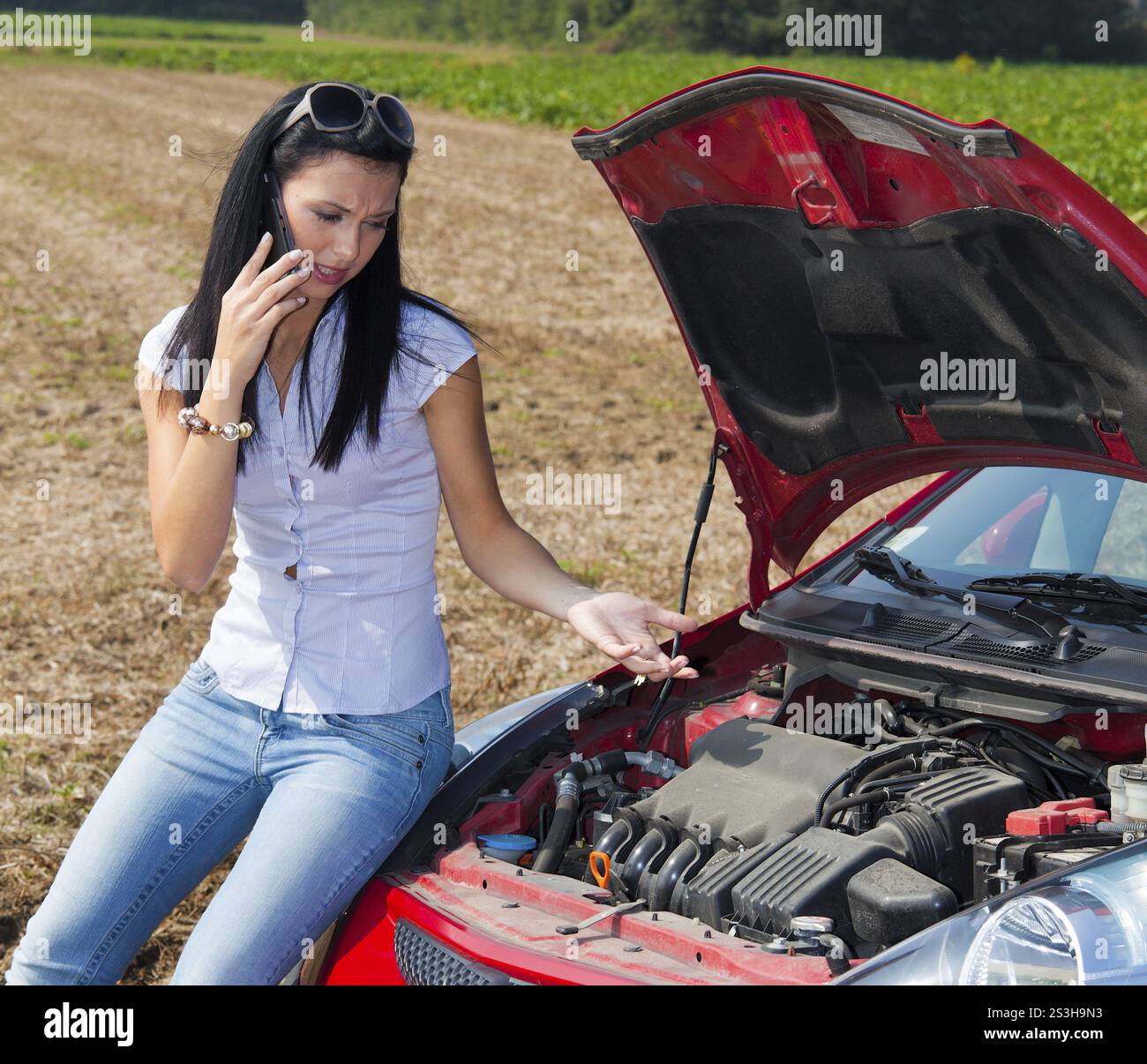 Young woman's car breaks down. Engine failure Stock Photo - Alamy