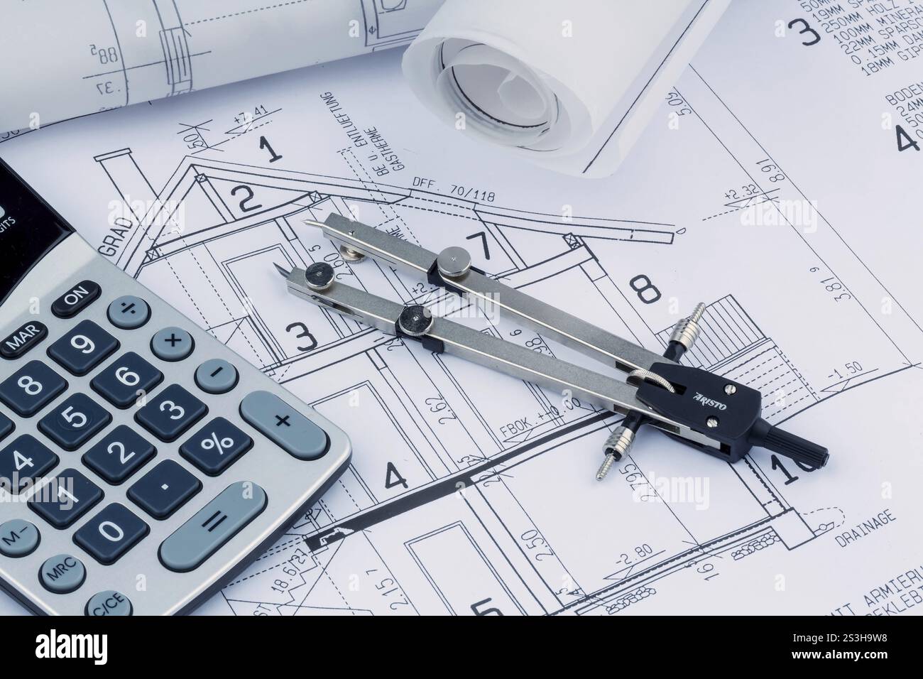 An architect's construction plan with a calculator. Symbolic photo for ...