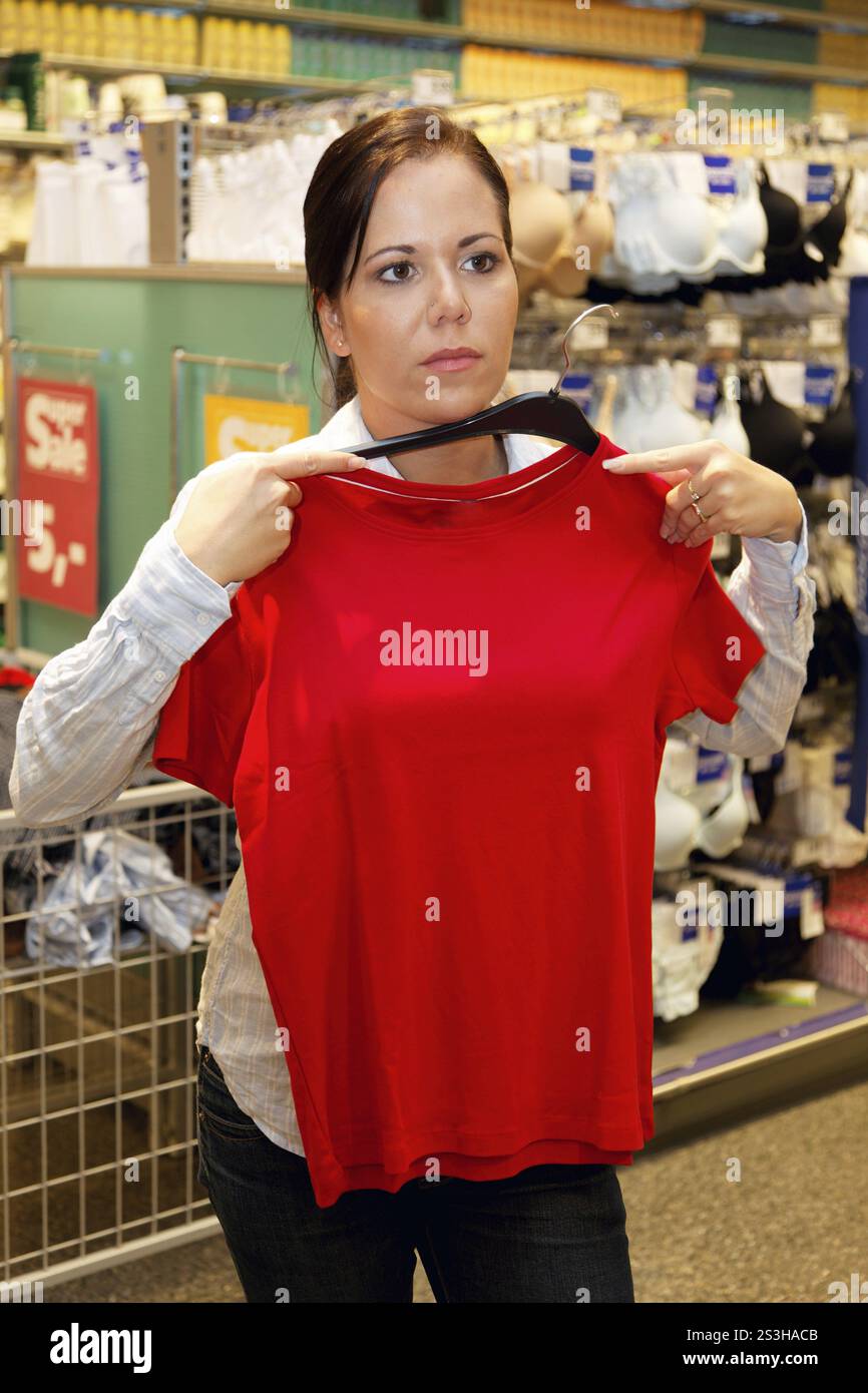 Young woman in a textile market with clothes Stock Photo - Alamy