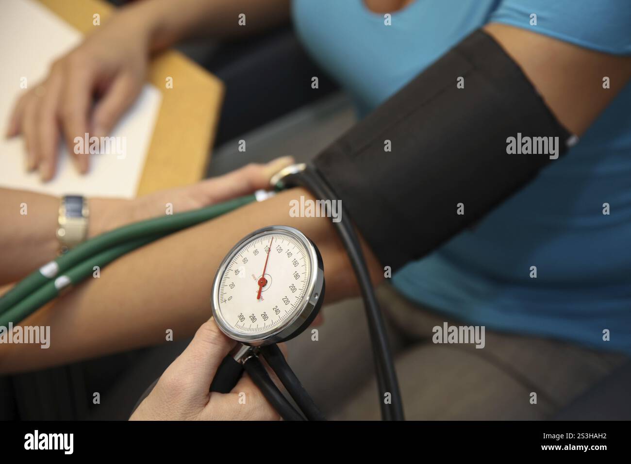 Doctor with a stethoscope measures patient's blood pressure Stock Photo ...