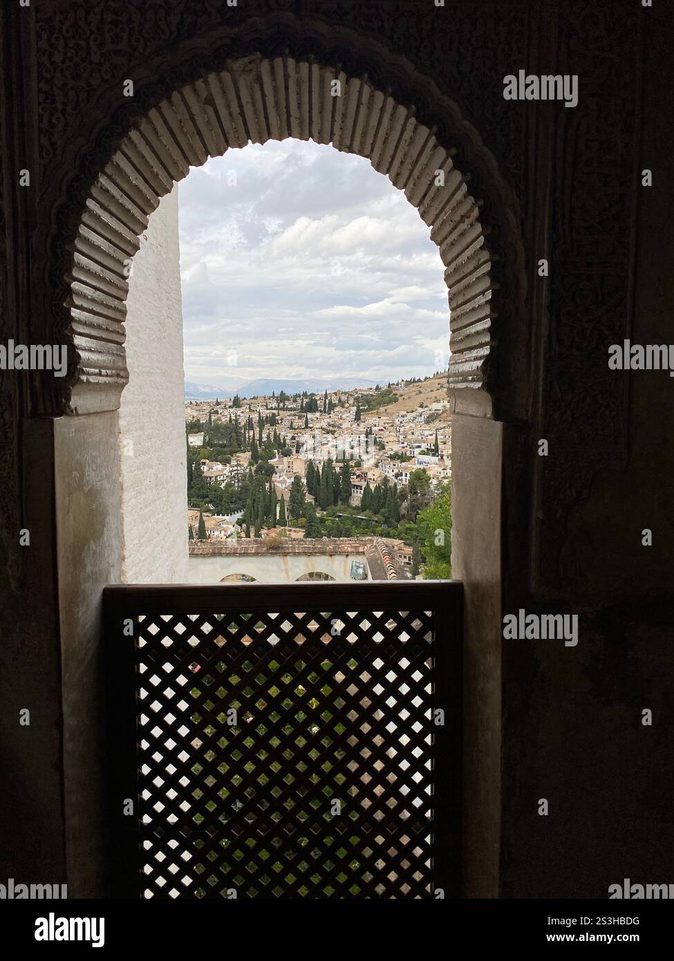 View of granada hills through an arched moorish window at the Alhambra ...