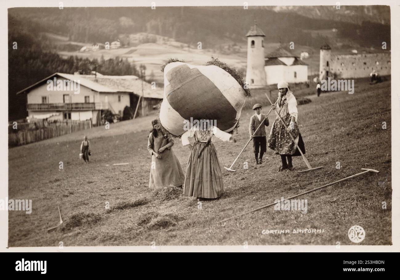 Woman carry huge bale of grass or hay, Cortina Dintorni Italy region ...