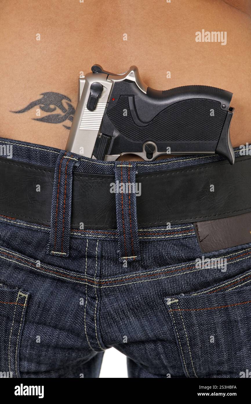 Girl's back with a concealed weapon Stock Photo - Alamy